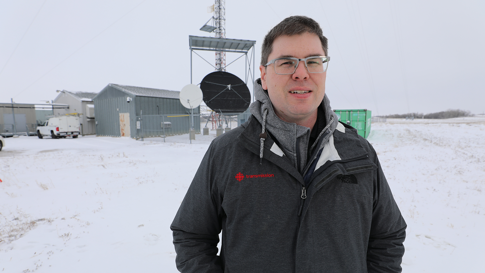 Ryan Goeres in front of the transmission tower