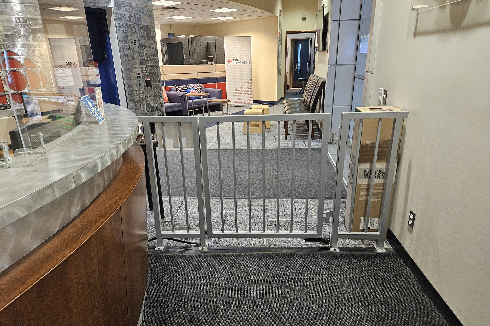 Metal security gate next to the security desk and employee ID badge ...