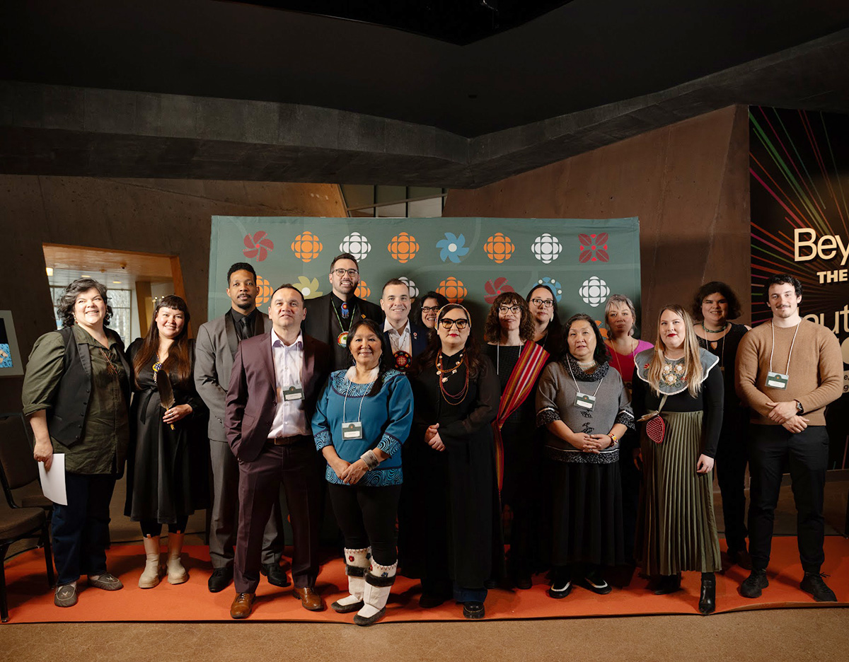 A group of people standing together in front of a backdrop with CBC and ...