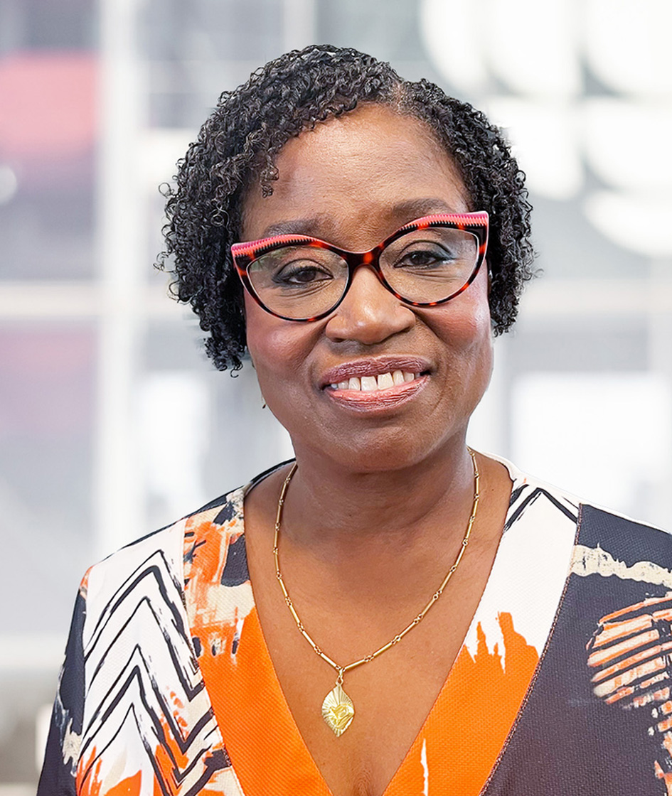 Maxime Bertrand wearing red glasses and an orange top