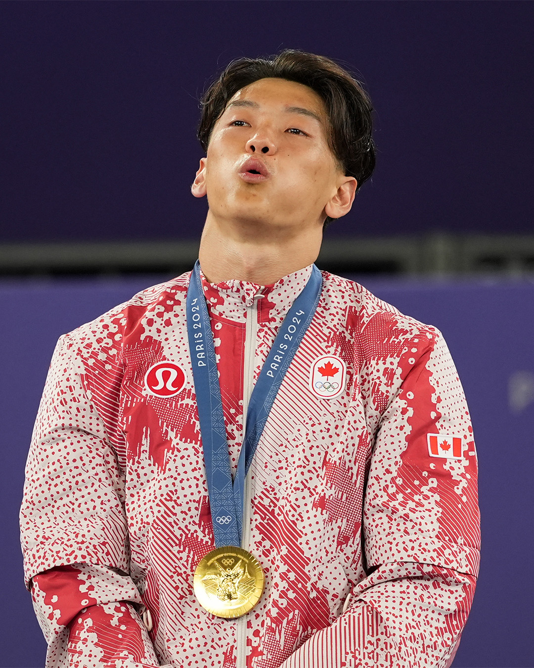 A man proudly wearing a gold medal around his neck, symbolizing his ...