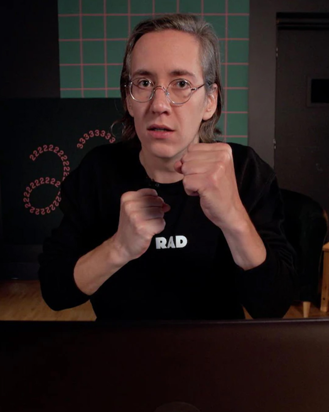 A Rad journalist, showing his fists, with a stack of newspapers beside ...
