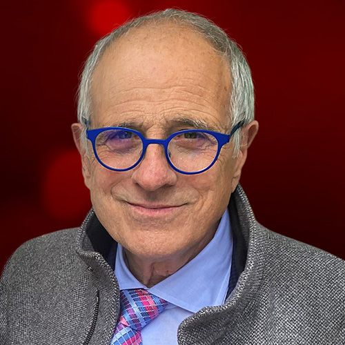 Bob Ezrin wearing blue glasses and a grey jacket